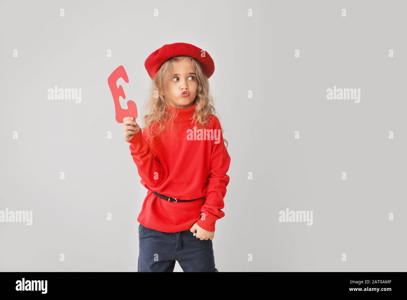 Cute little girl with red letter on grey background Stock Photo - Alamy