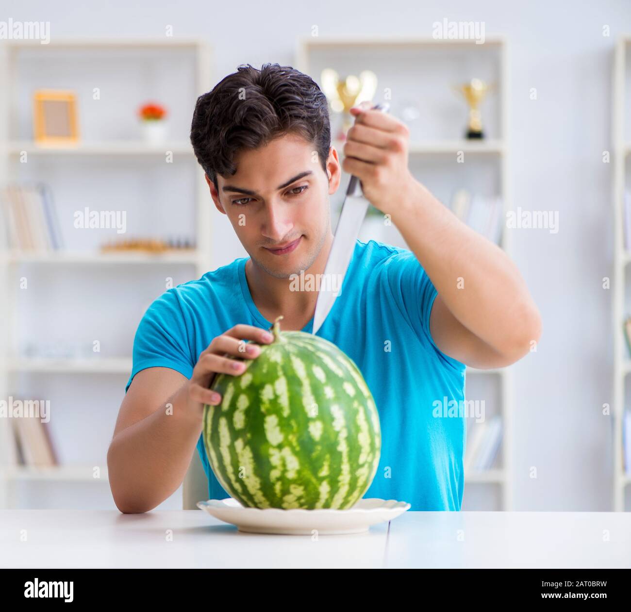 The man eating watermelon at home Stock Photo - Alamy