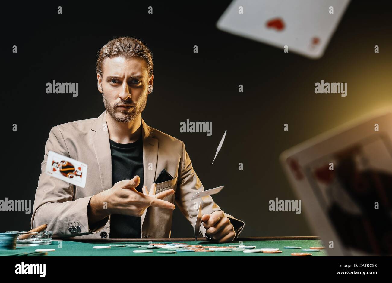 Young man throwing playing cards hi-res stock photography and images ...