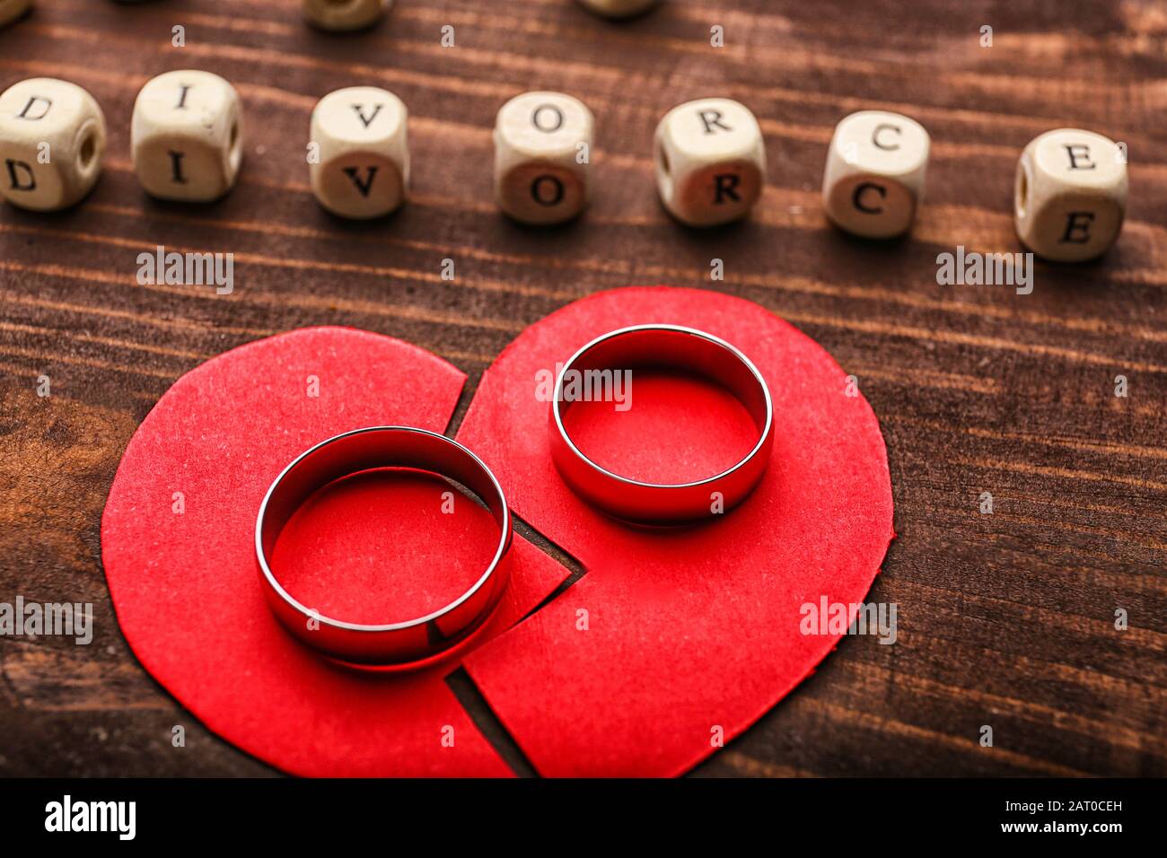 Broken heart, rings and word DIVORCE made of cubes on wooden background ...