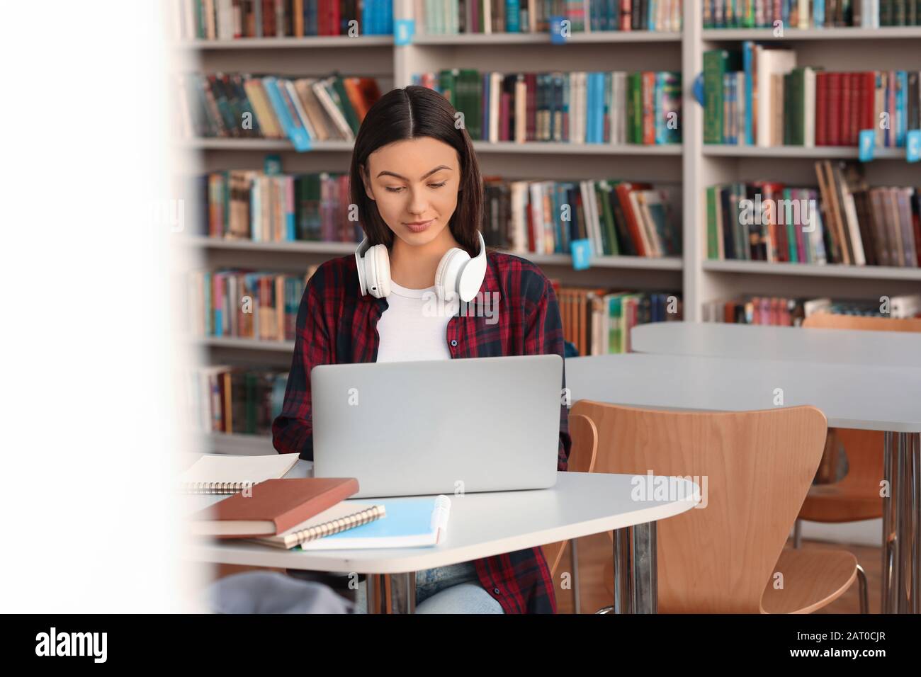 Female student preparing for exam in library Stock Photo - Alamy