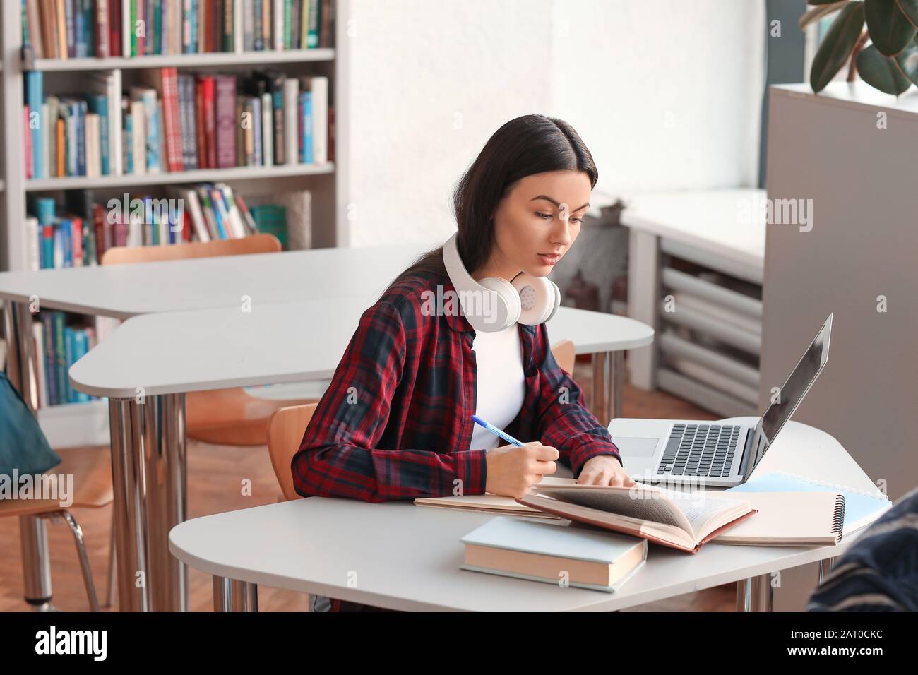 Female student preparing for exam in library Stock Photo - Alamy