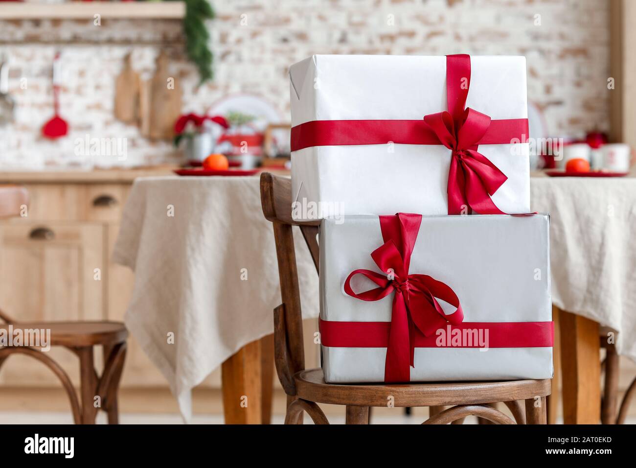 Beautiful Christmas gifts on chair in dining room Stock Photo - Alamy