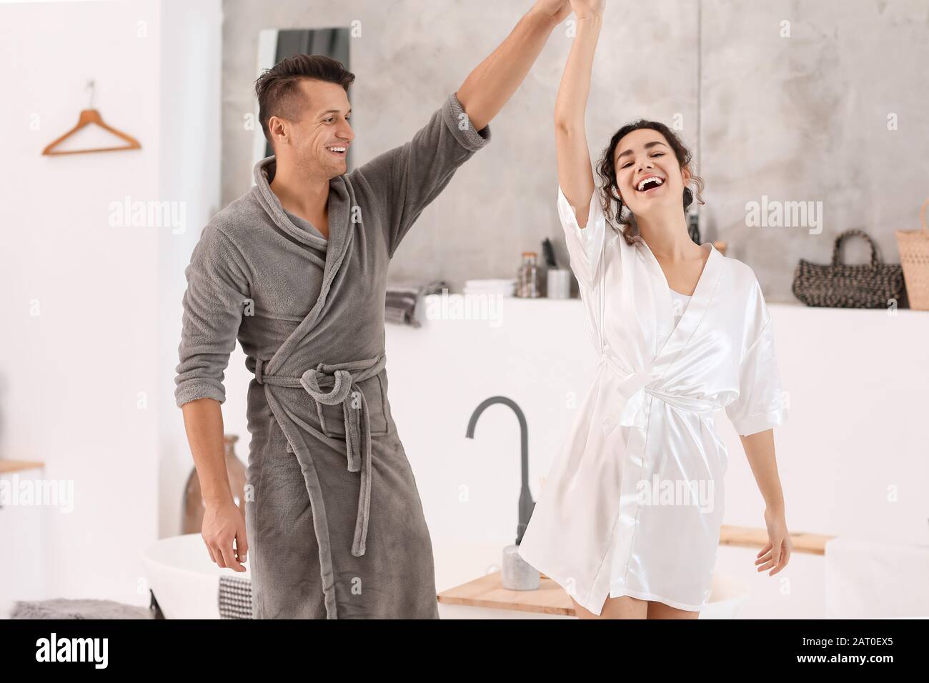 Happy young couple dancing in bathroom at home Stock Photo - Alamy