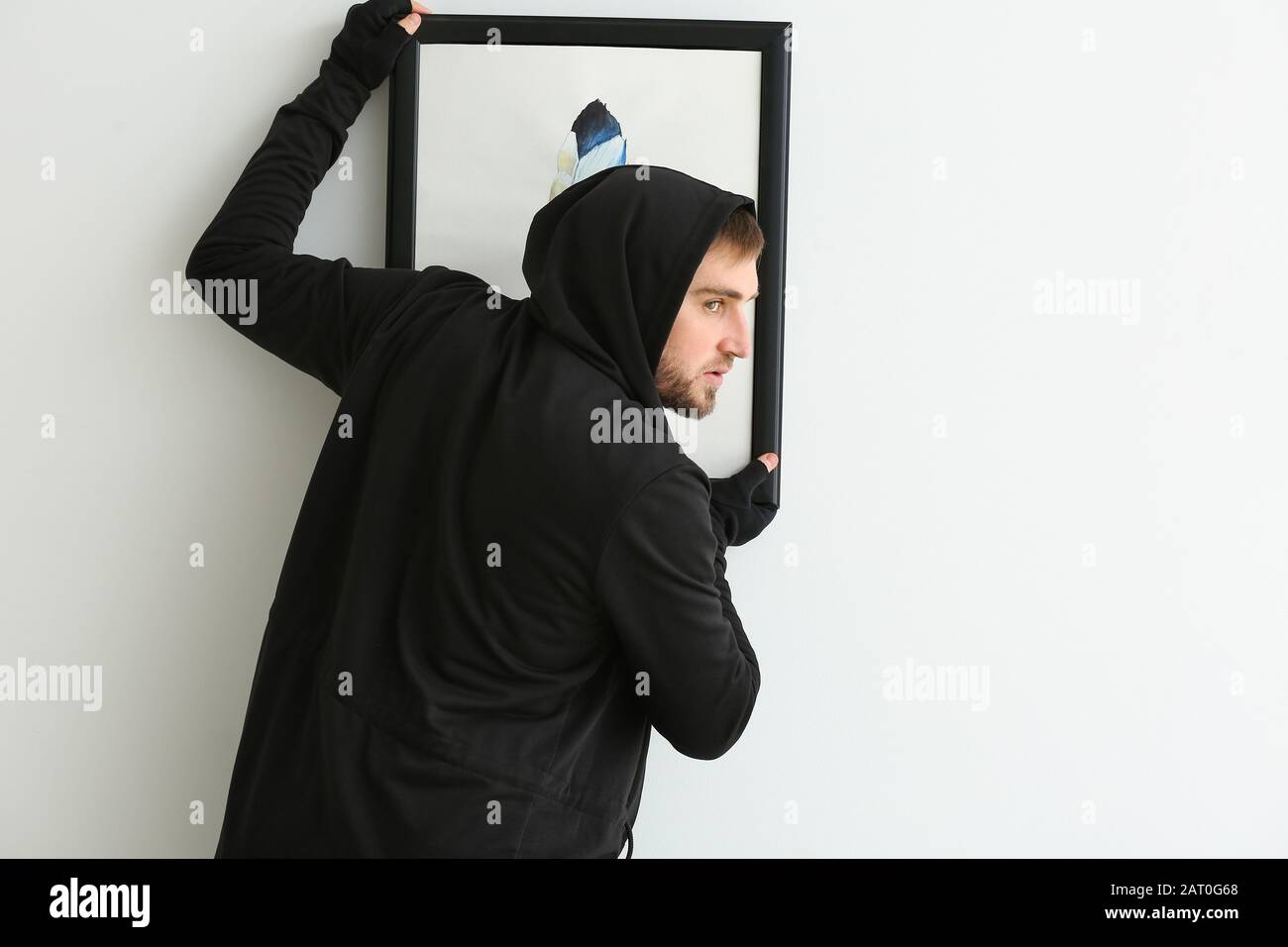 Thief stealing picture from art gallery Stock Photo - Alamy