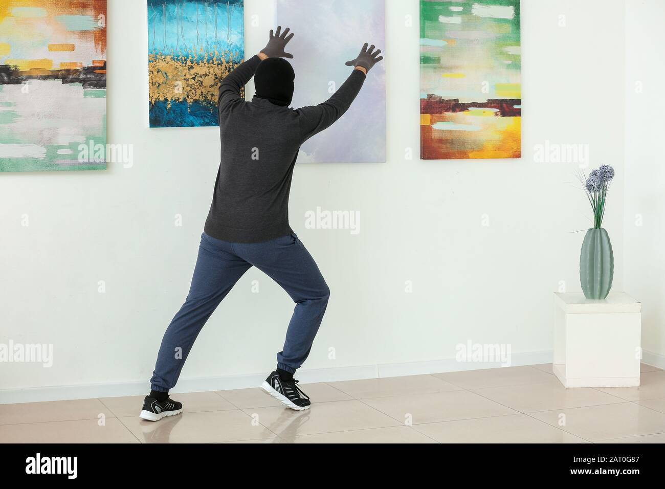 Thief stealing picture from art gallery Stock Photo - Alamy