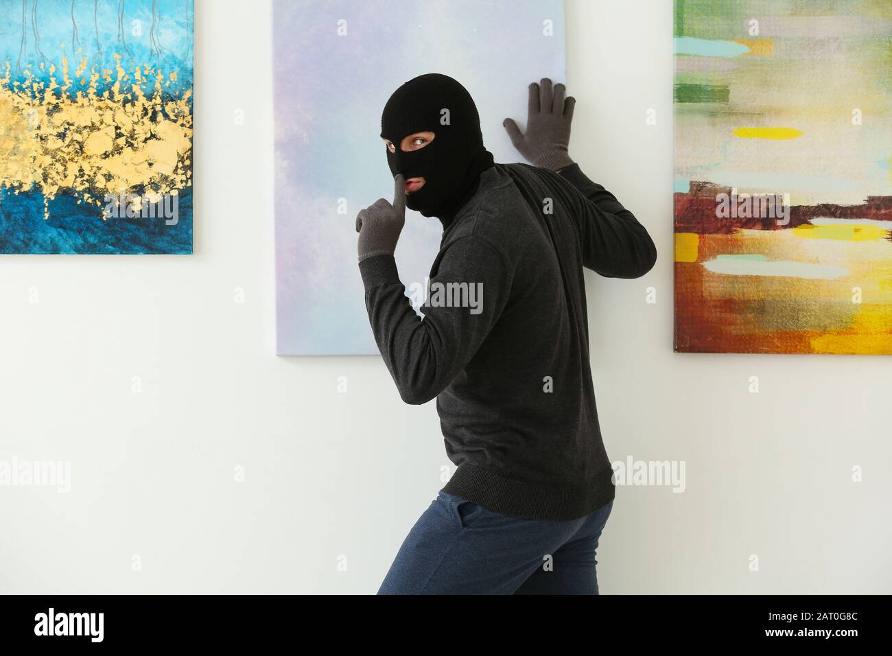 Thief stealing picture from art gallery Stock Photo - Alamy