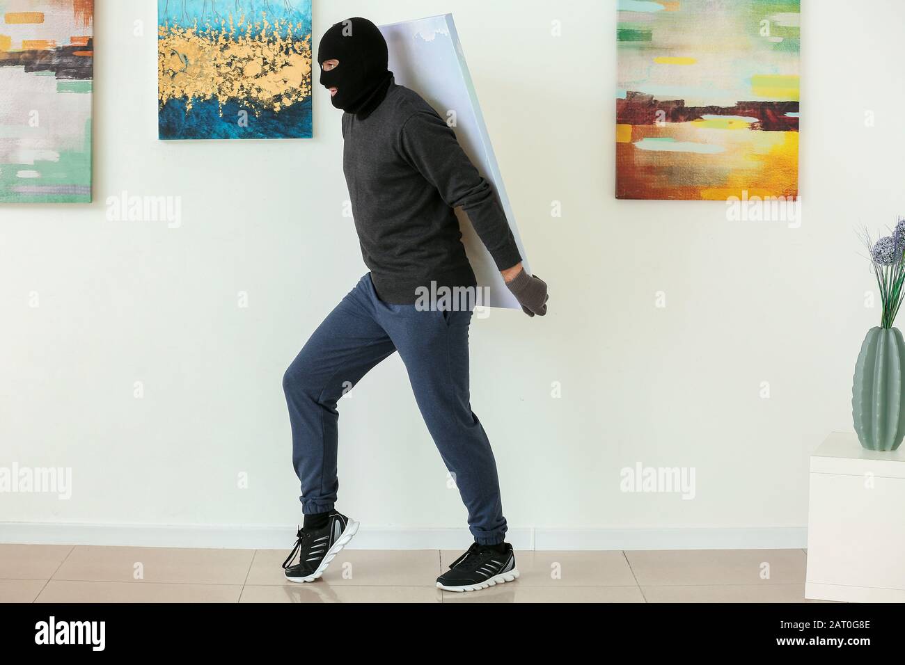 Thief stealing picture from art gallery Stock Photo - Alamy