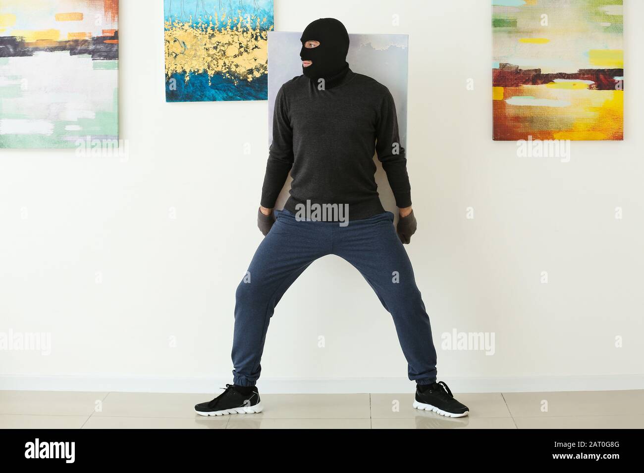 Thief stealing picture from art gallery Stock Photo - Alamy