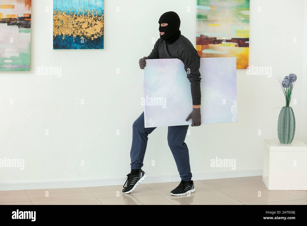 Thief stealing picture from art gallery Stock Photo - Alamy