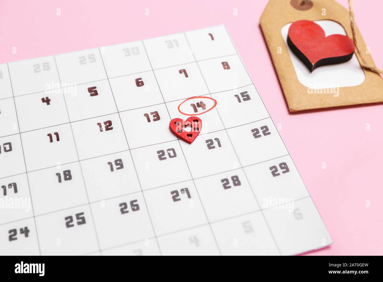 Calendar with marked date of Valentine's Day on color background Stock ...