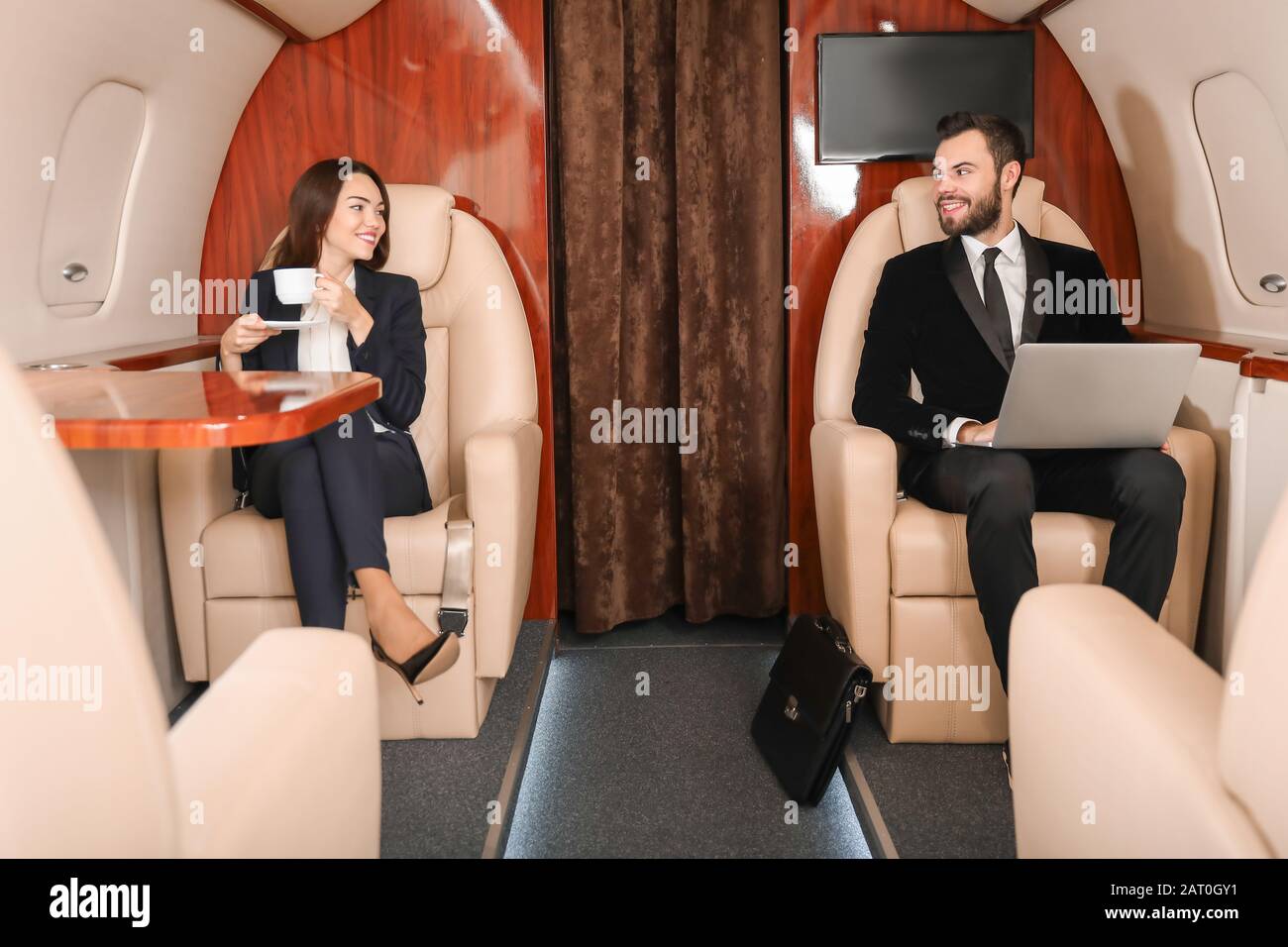 Business colleagues on board the modern private airplane Stock Photo ...