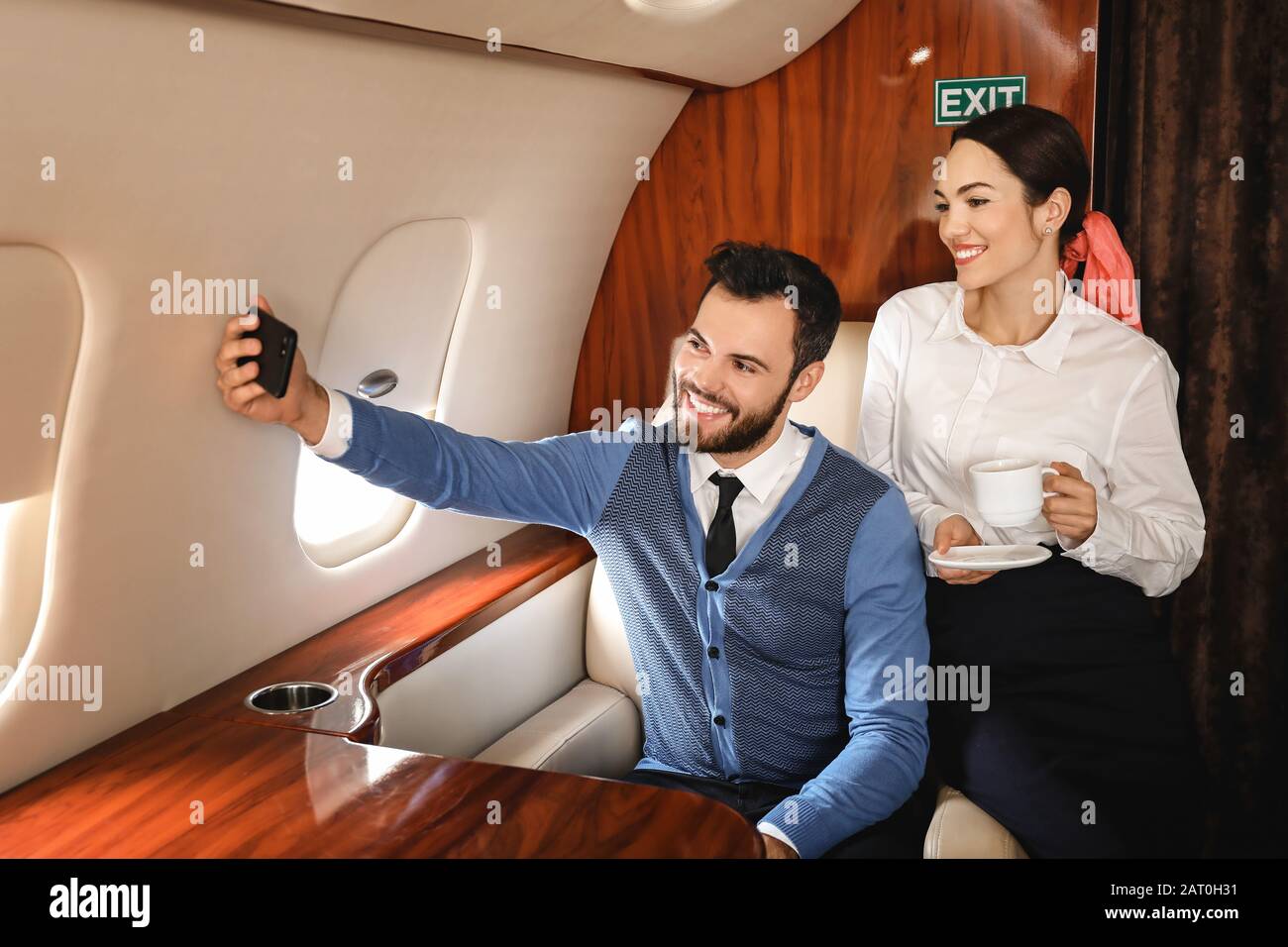 Couple taking selfie on board the modern private airplane Stock Photo ...