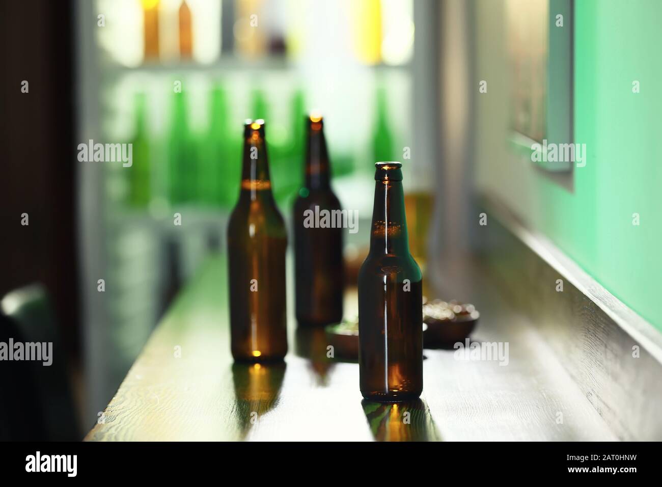 Bottles of beer on bar counter Stock Photo - Alamy