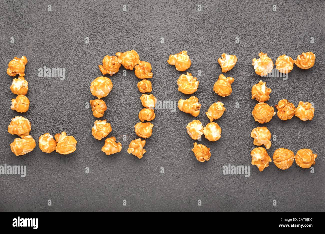 Word LOVE made of tasty popcorn on dark background Stock Photo - Alamy