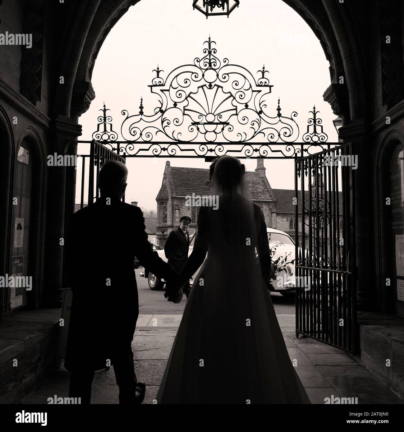 A Bride and Groom leaving the church on getting married with their ...