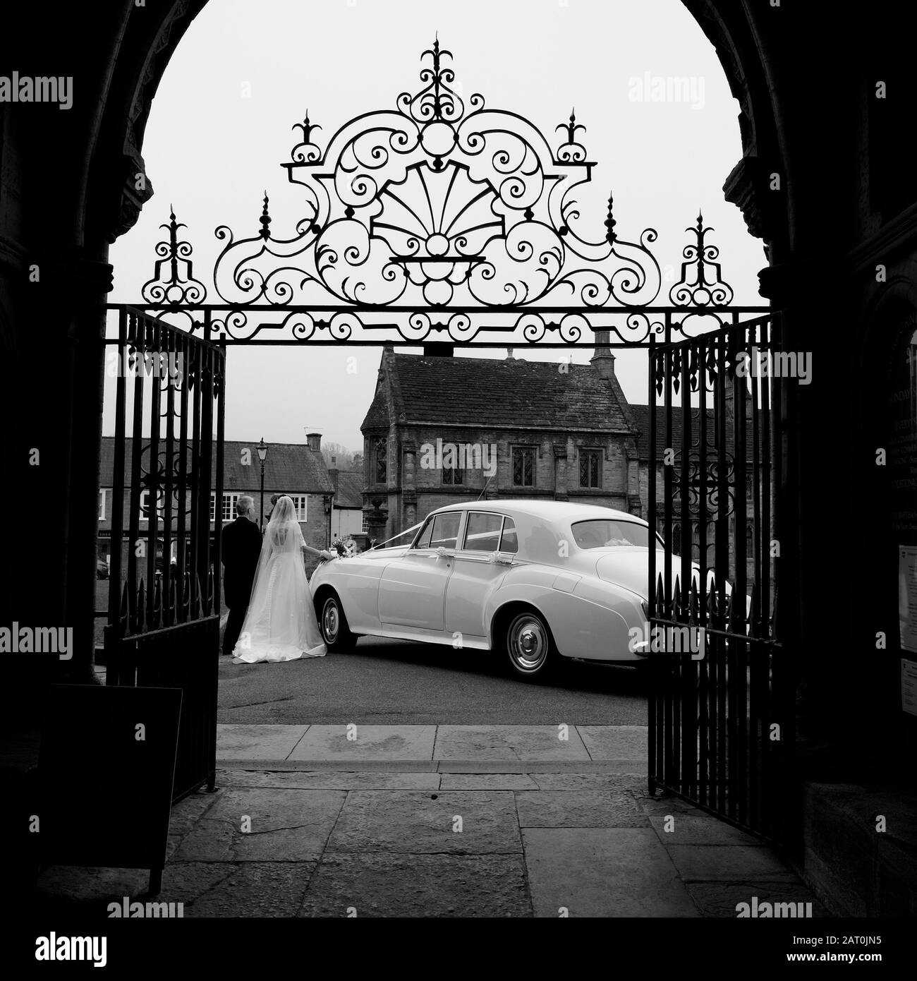 A Bride and Groom leaving the church on getting married with their ...