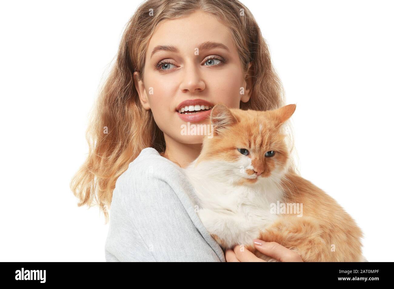 Beautiful young woman with cute cat on white background Stock Photo - Alamy