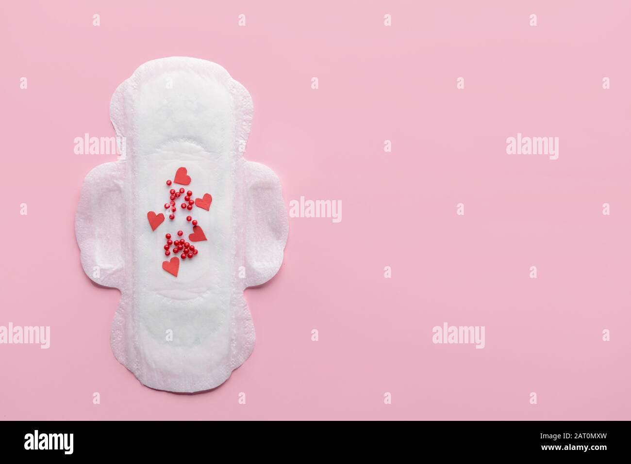 Menstrual pad with red beads on color background. Menstruation concept ...