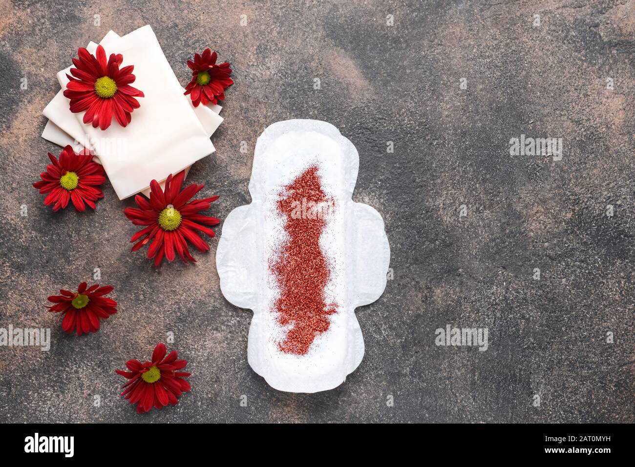 Menstrual pads with flowers and glitter on grey background ...