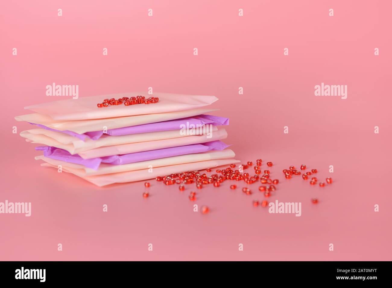 Menstrual pads with red beads on color background. Menstruation concept ...