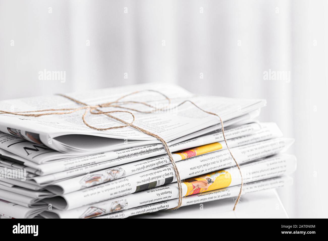 Stack of newspapers on table in room Stock Photo - Alamy
