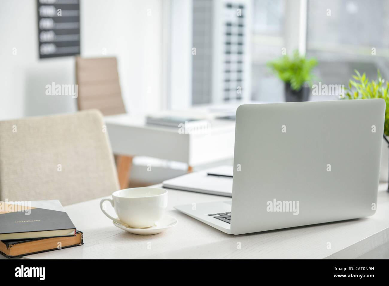 Modern laptop on comfortable workplace in room Stock Photo - Alamy