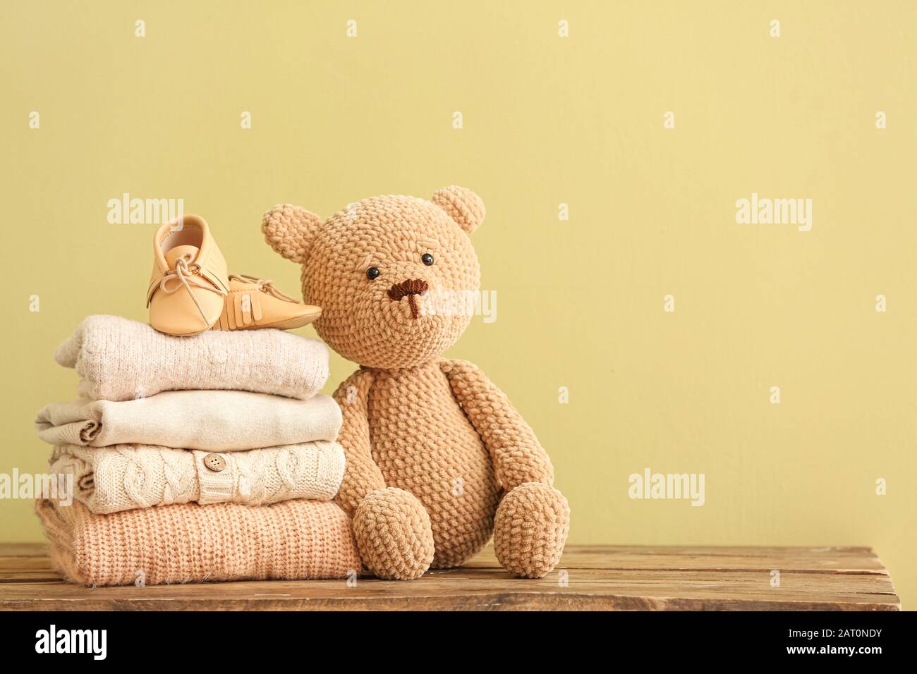 Stack of baby clothes and toy on table Stock Photo - Alamy