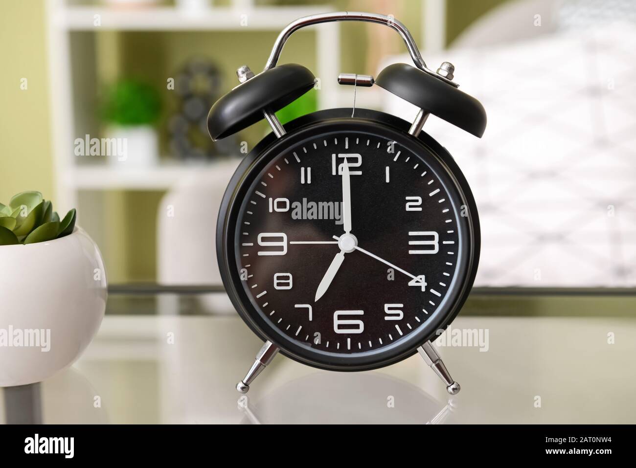 Alarm clock on table in room Stock Photo - Alamy