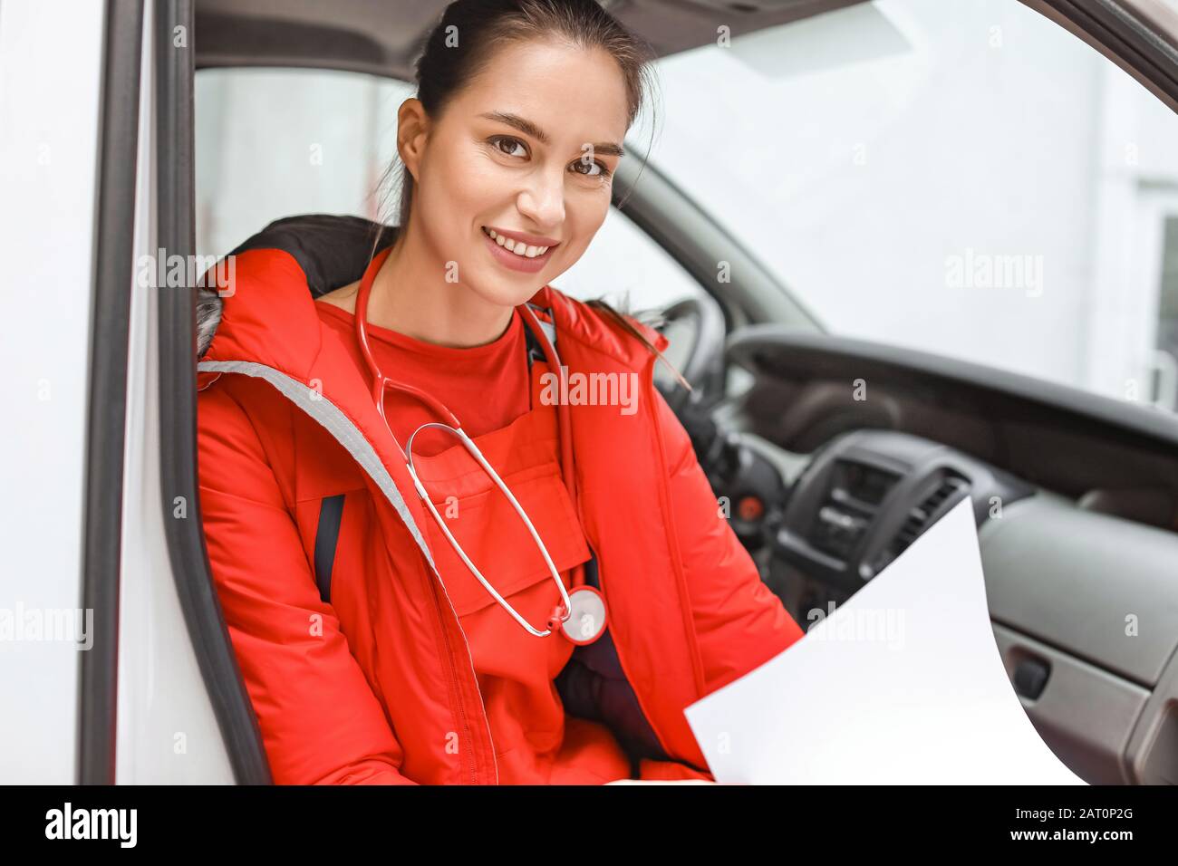 Female paramedic sitting in ambulance car Stock Photo - Alamy