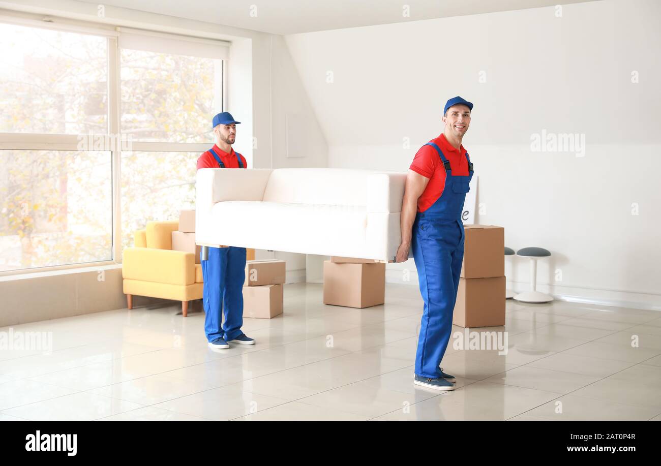 Loaders carrying furniture on moving day Stock Photo - Alamy