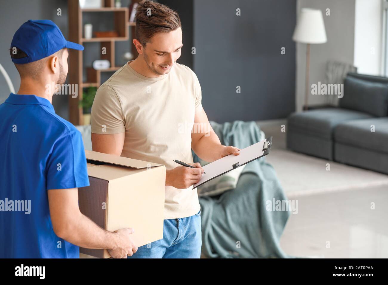 Man signing documents to confirm receiving of order from delivery ...
