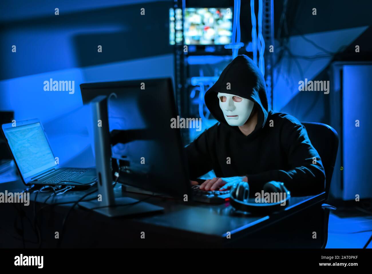 Professional hacker using computer in dark room Stock Photo - Alamy
