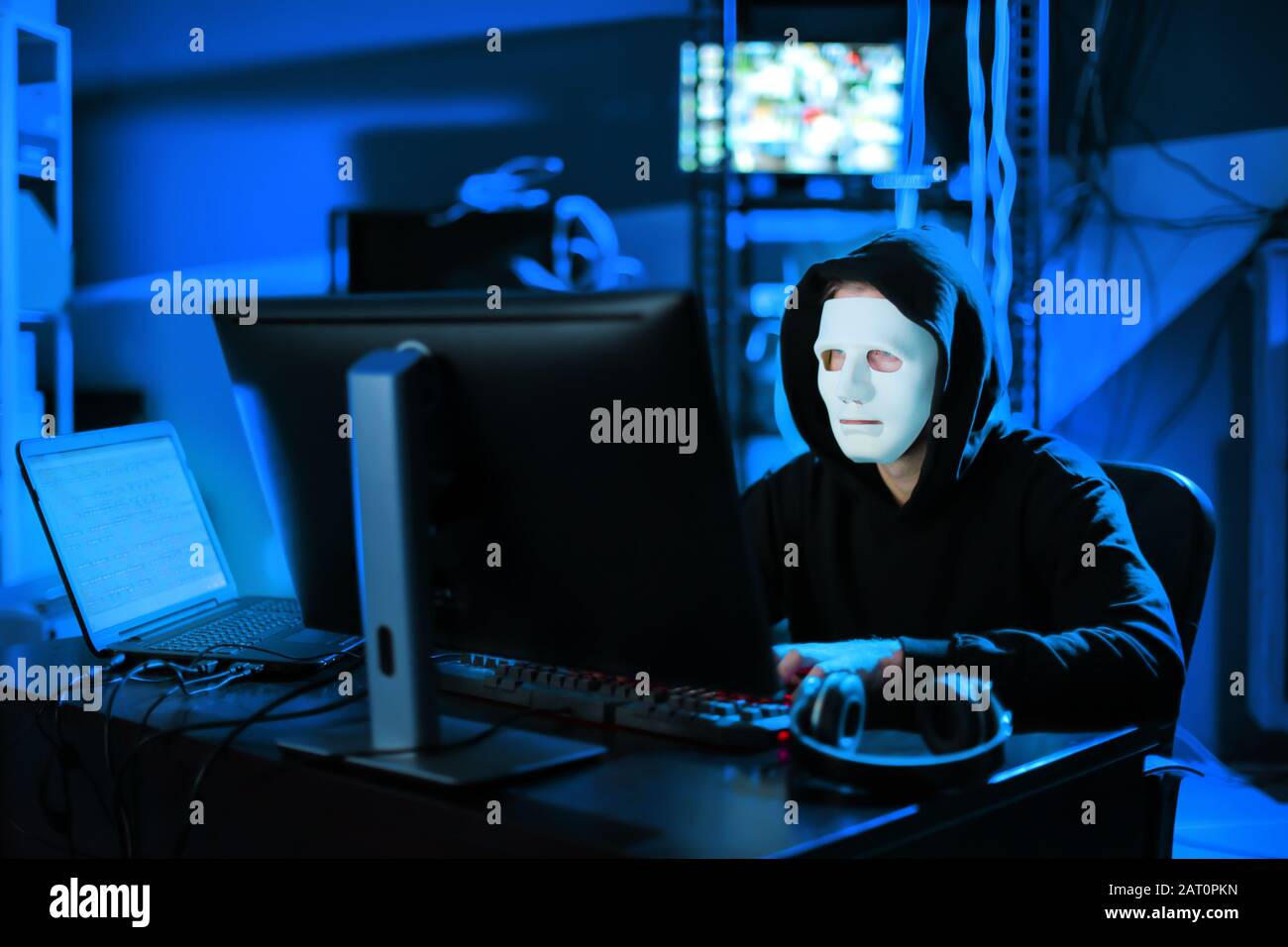 Professional hacker using computer in dark room Stock Photo - Alamy