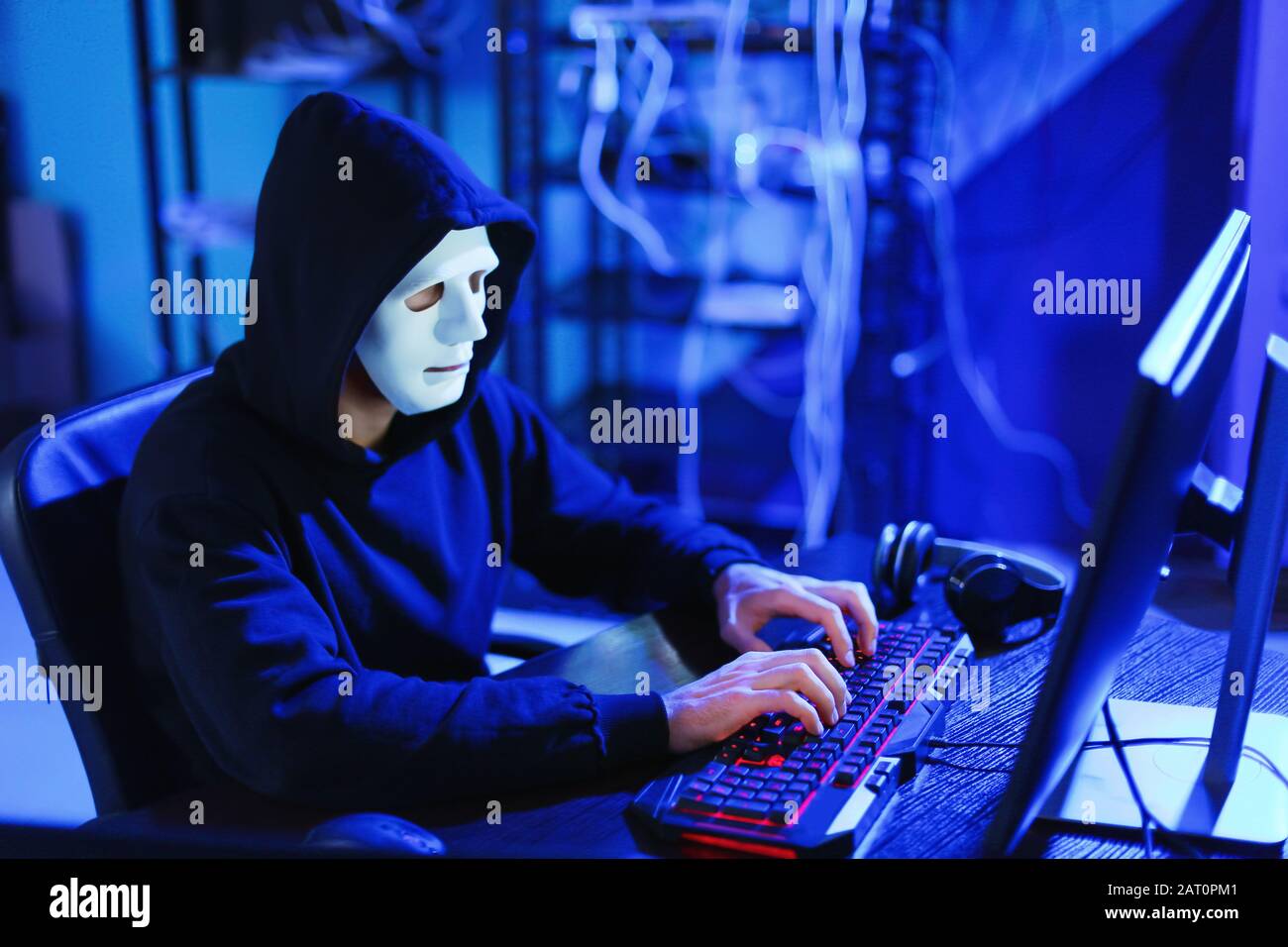 Professional hacker using computer in dark room Stock Photo - Alamy