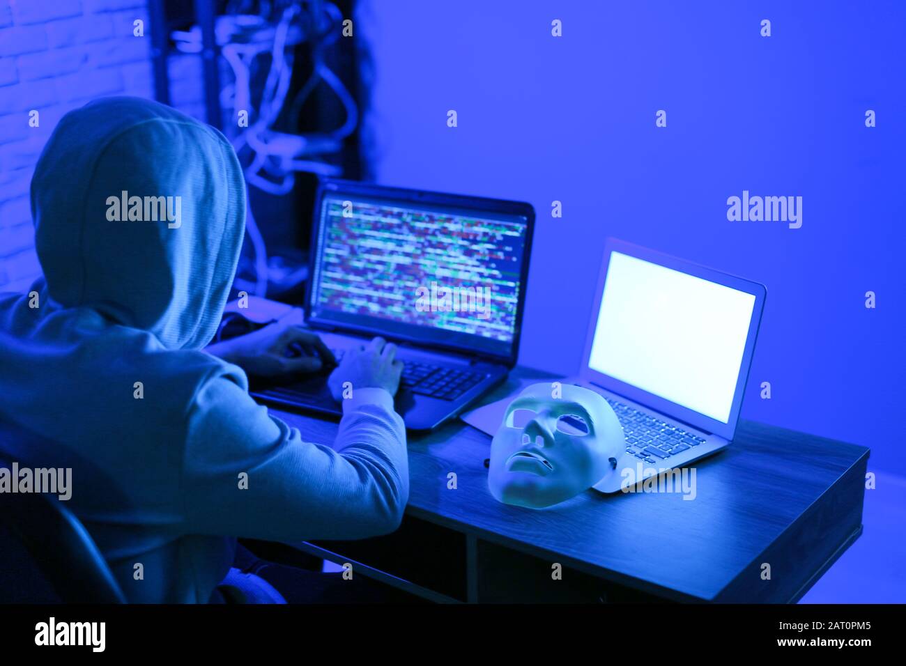 Professional hacker using laptop in dark room Stock Photo - Alamy
