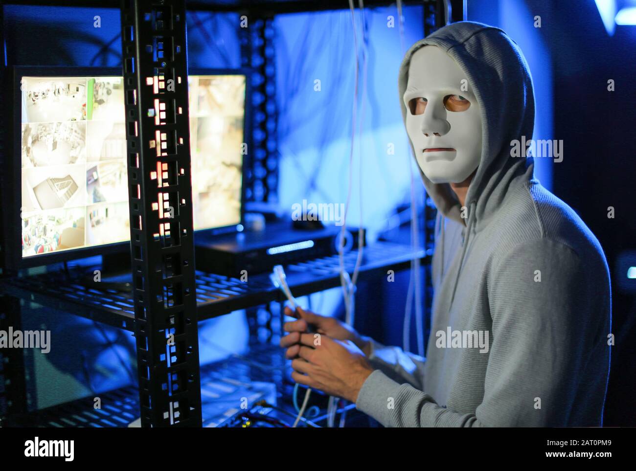 Professional hacker near computer in dark room Stock Photo - Alamy