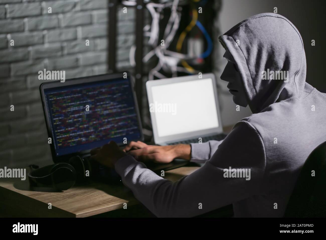 Professional hacker using laptop in dark room Stock Photo - Alamy