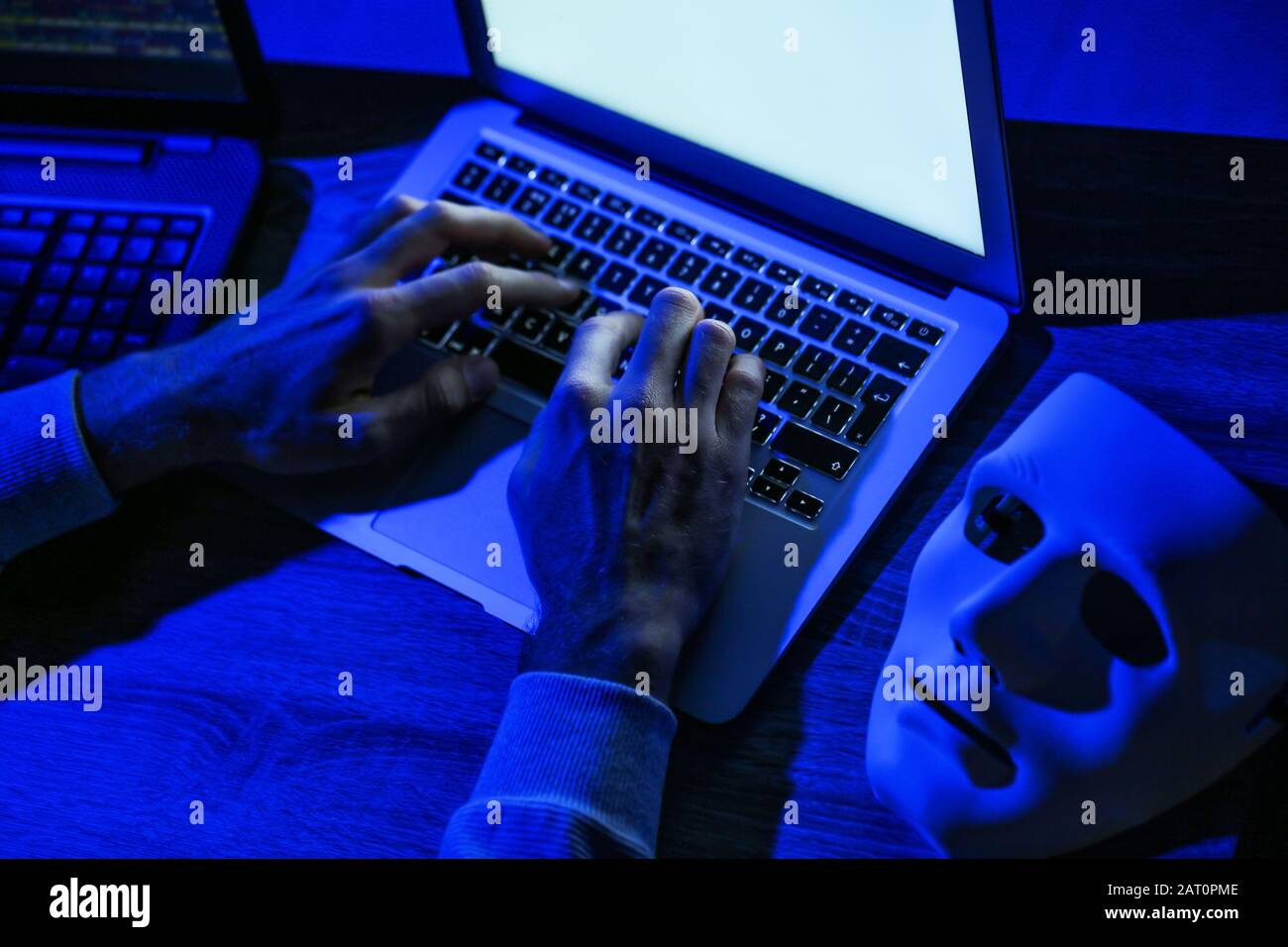 Professional hacker using laptop in dark room, closeup Stock Photo - Alamy