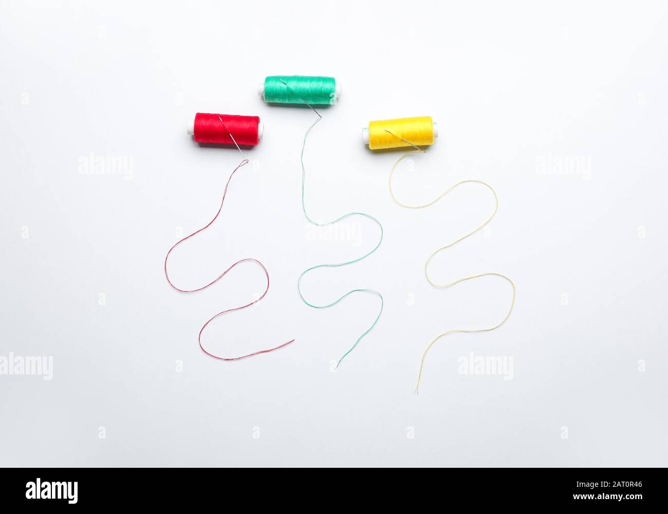 Sewing threads on white background Stock Photo - Alamy
