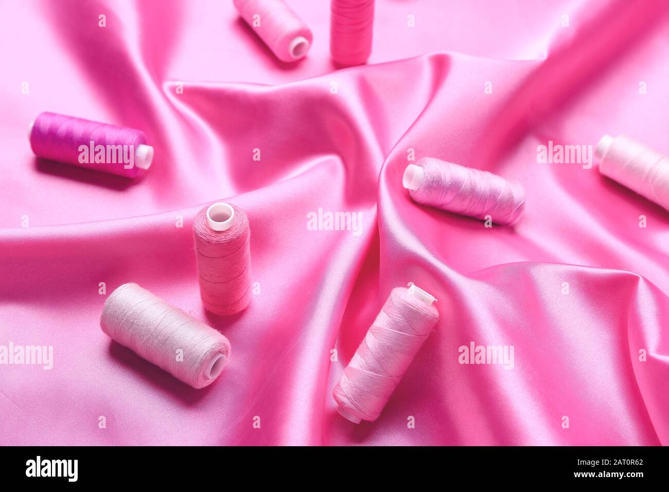 Set of sewing threads on fabric Stock Photo - Alamy