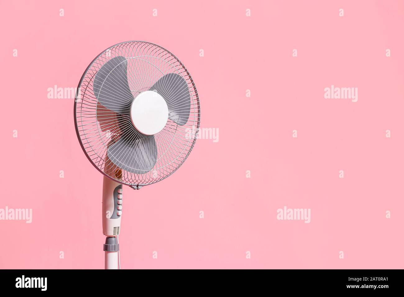 Electric fan on color background Stock Photo - Alamy