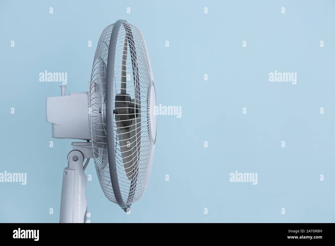 Modern electric fan on color background Stock Photo - Alamy