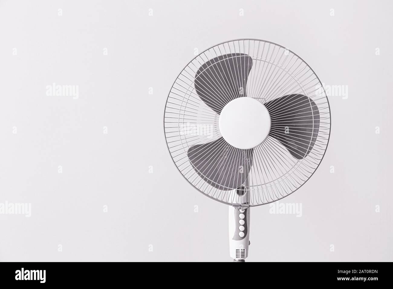 Electric fan on light background Stock Photo - Alamy
