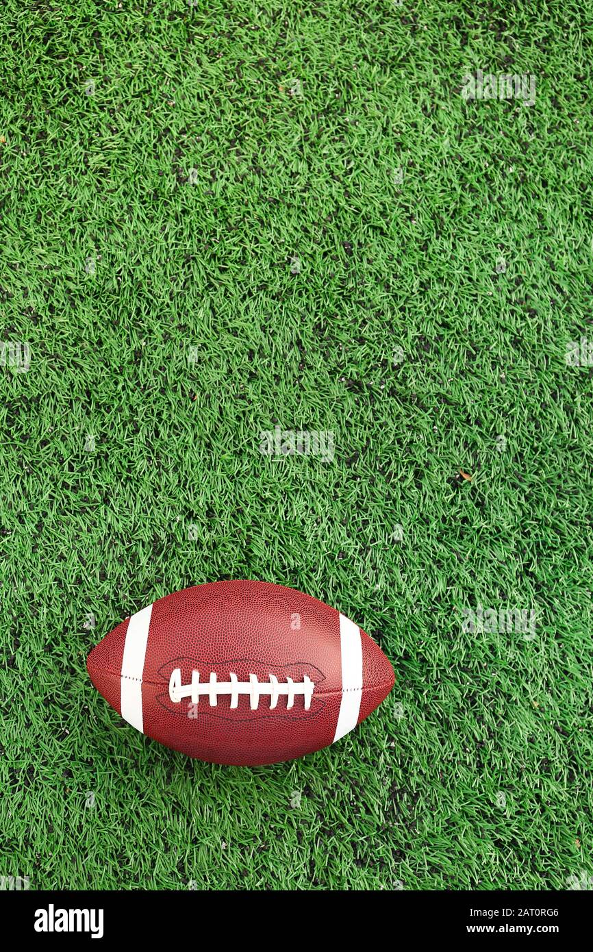 Rugby ball on green field outdoors Stock Photo - Alamy