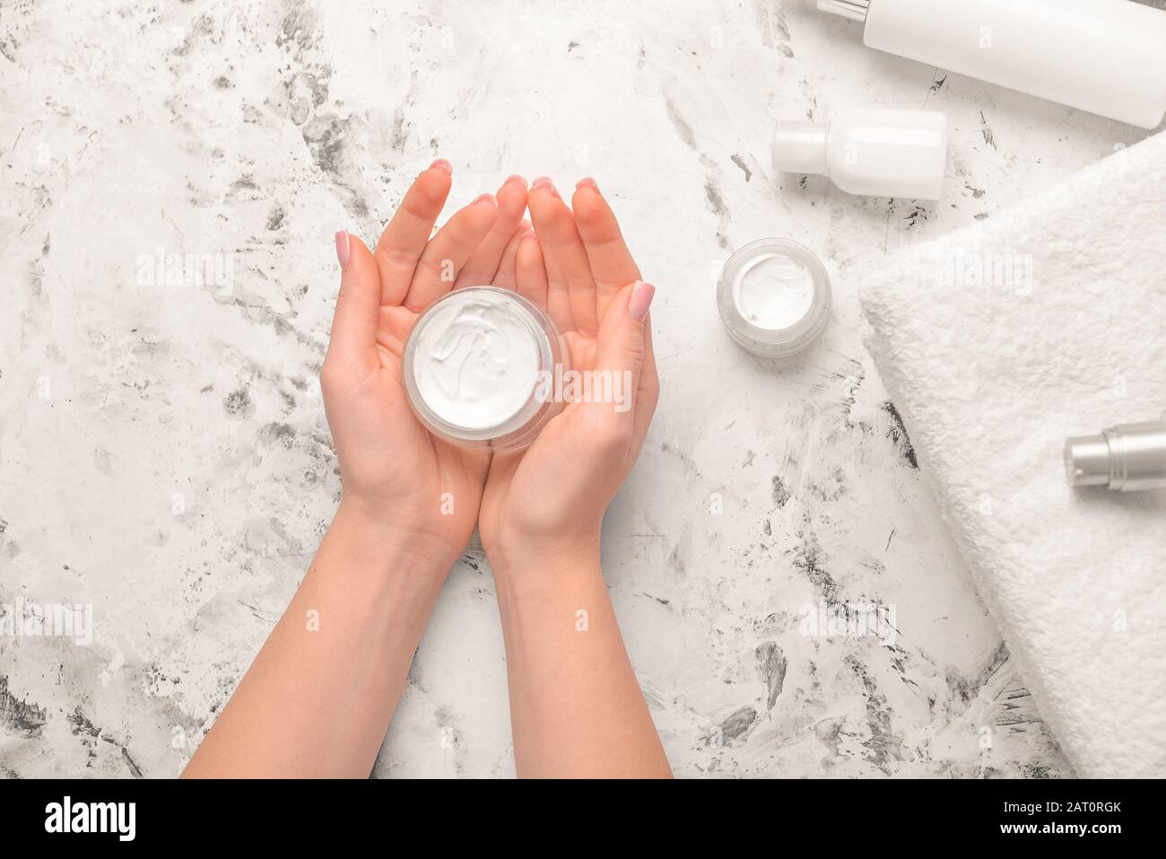 Hands of young woman and cream on white background Stock Photo - Alamy