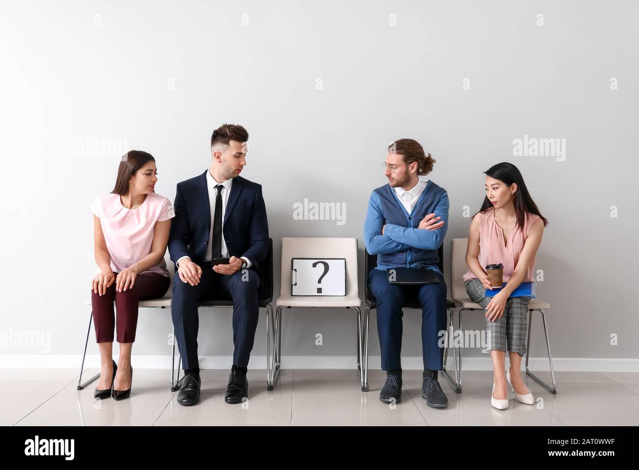 Young people waiting for job interview indoors Stock Photo - Alamy