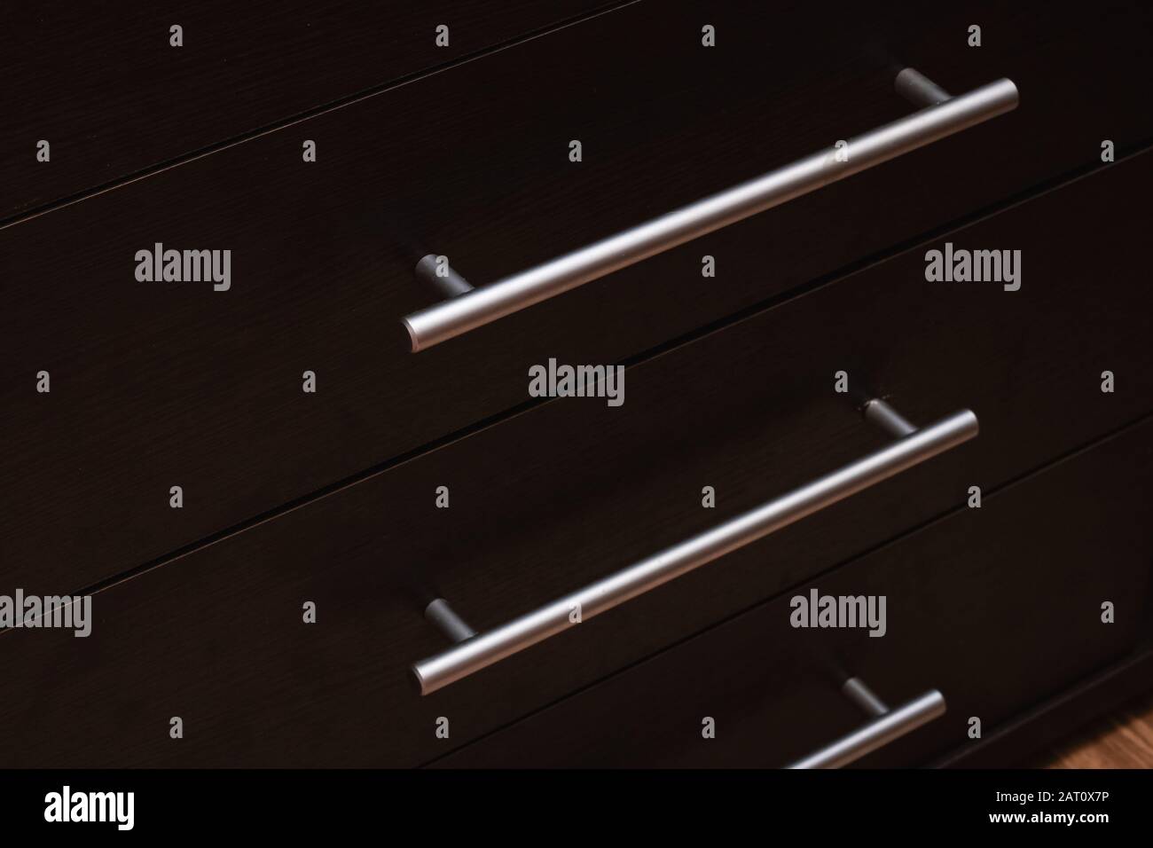 Wooden drawer shelves with metal handles closeup Stock Photo - Alamy