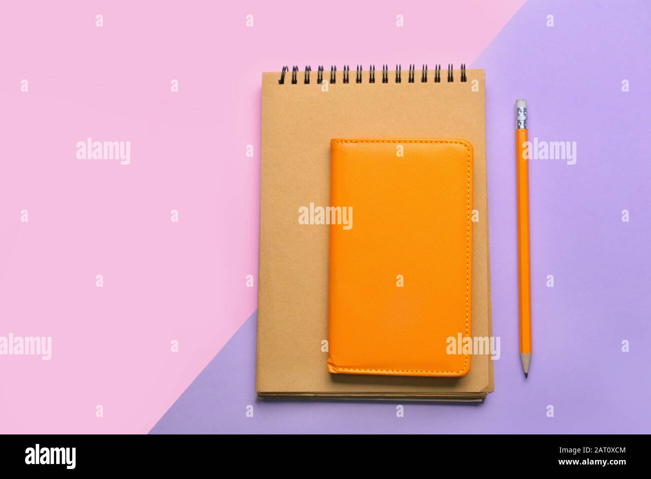 Stylish notebooks with pencil on color background Stock Photo - Alamy