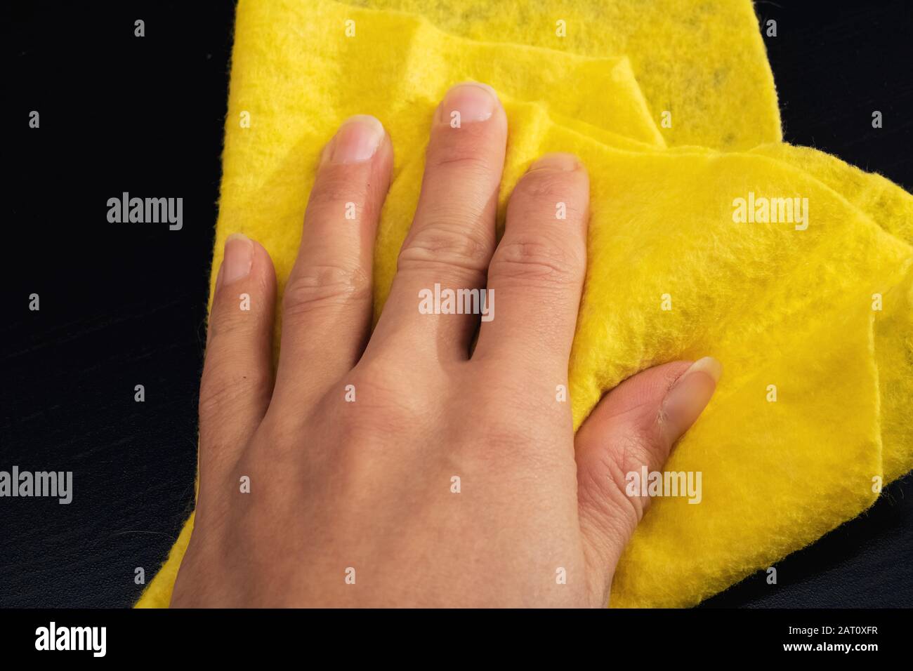 Yellow rag in the hand close up Stock Photo - Alamy